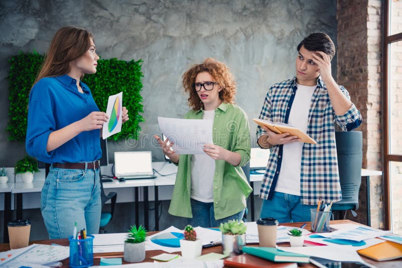Three Diverse Colleagues Discussing a Business Presentation in a Modern ...