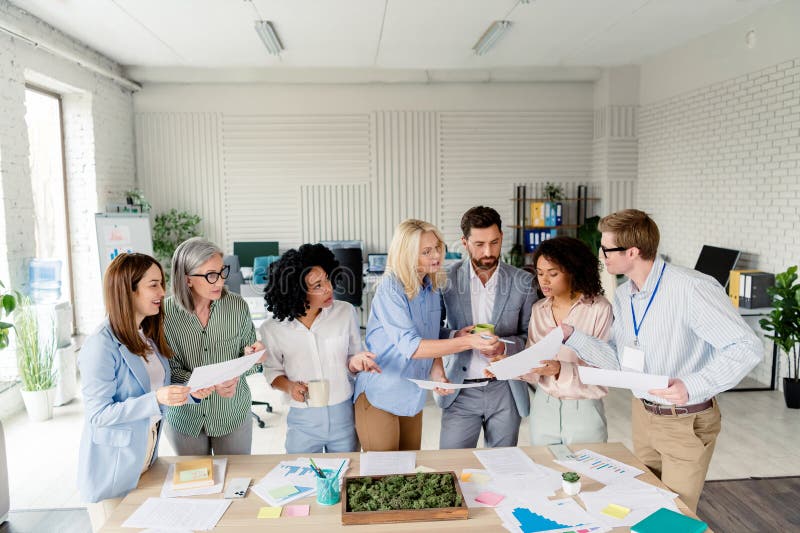 Colleagues Collaborating on a Business Project in a Bright Office Stock ...