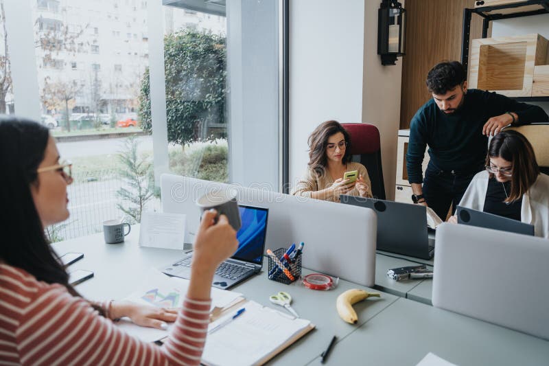 A Successful Group of Coworkers Collaborating and Discussing Ideas in a ...