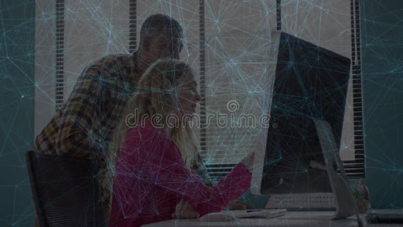 Colleagues Collaborating at Modern Tech Office Desk, Exploring Blue ...