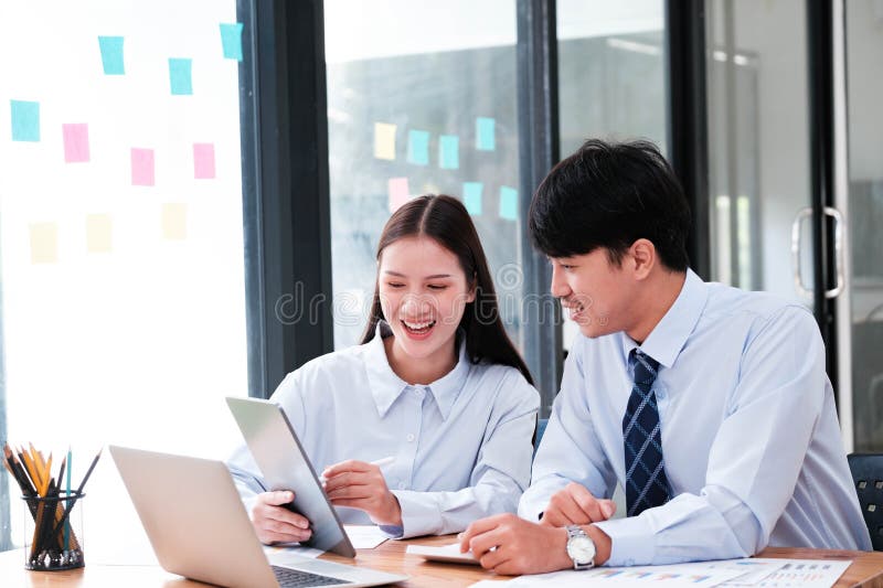 Colleagues Collaborating on Project at Office Desk Stock Photo - Image ...