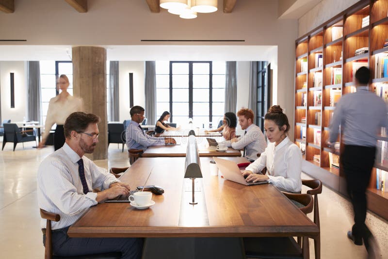 Colleagues at Desks in a Busy Open Plan Office, Close Up Stock Image ...