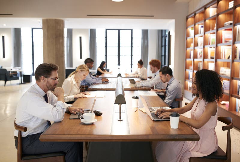 Colleagues at Desks in a Busy Open Plan Office, Close Up Stock Image ...