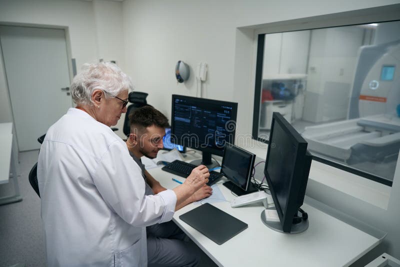 Colleagues Diagnosticians Perform MRI of the Brain Stock Photo - Image ...