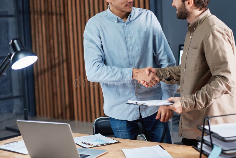 Colleagues Discussing a Business Document Late at Night in the O Stock ...