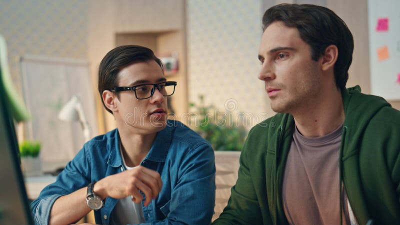 Colleagues Discussing Computer Project Together Closeup. Office Guys ...