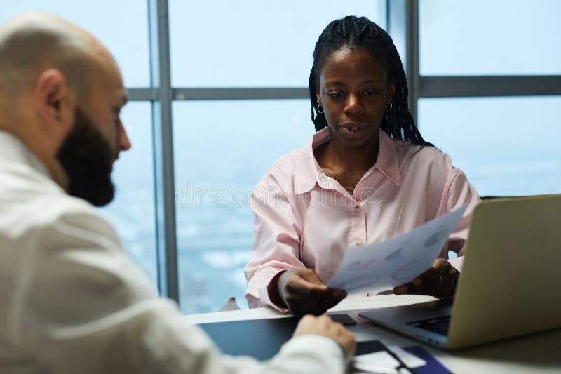 Colleagues Discussing Documents in Office Stock Image - Image of ...
