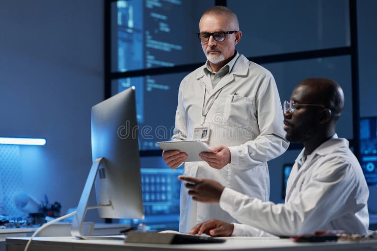 Colleagues Discussing Program on Computer Stock Image - Image of ...