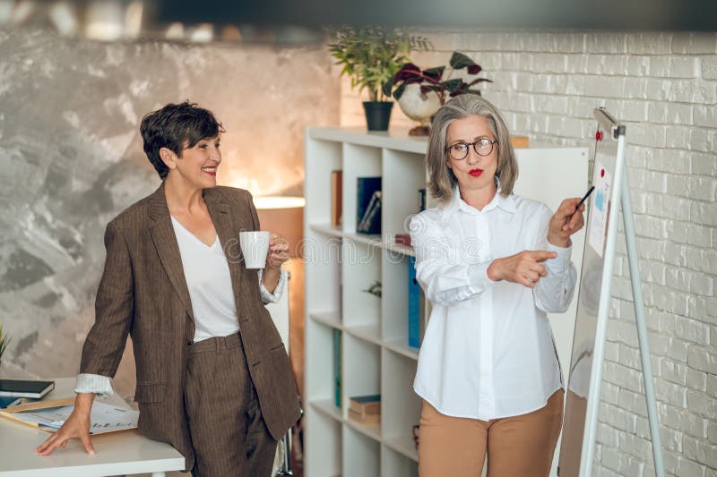 Colleagues Discussing Project Details and Looking Involved Stock Photo ...
