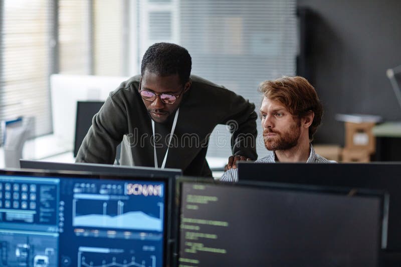 Colleagues Discussing Work Issues Over Computer Stock Image - Image of ...