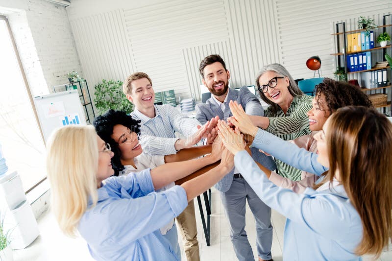 Diverse Group of Coworkers Celebrating Teamwork in a Modern Office ...