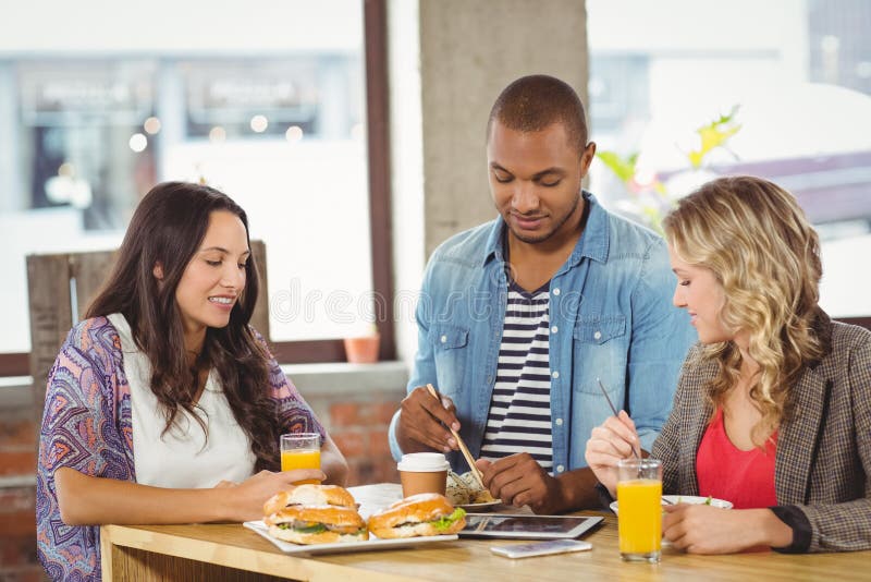 Colleagues Having Breakfast in Office Stock Photo - Image of blonde ...