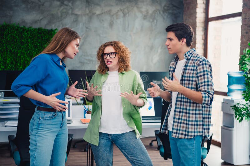 Colleagues Having a Disagreement in a Modern Open-plan Office Setting ...