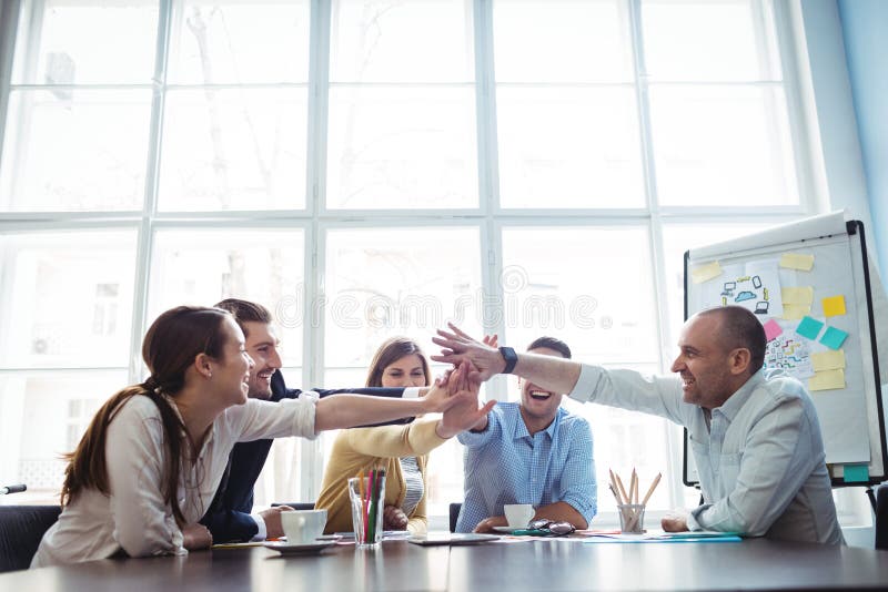 Colleagues High-five in Meeting Room Stock Photo - Image of meeting ...