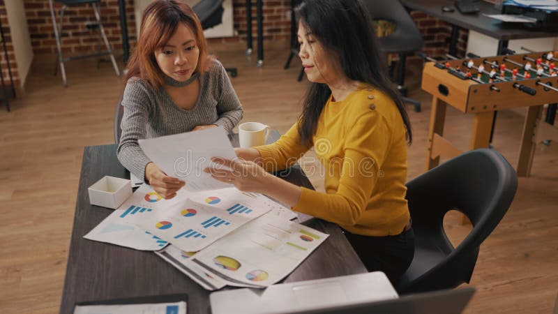 Colleagues Looking at Charts and Graphs on Documents Stock Photo ...
