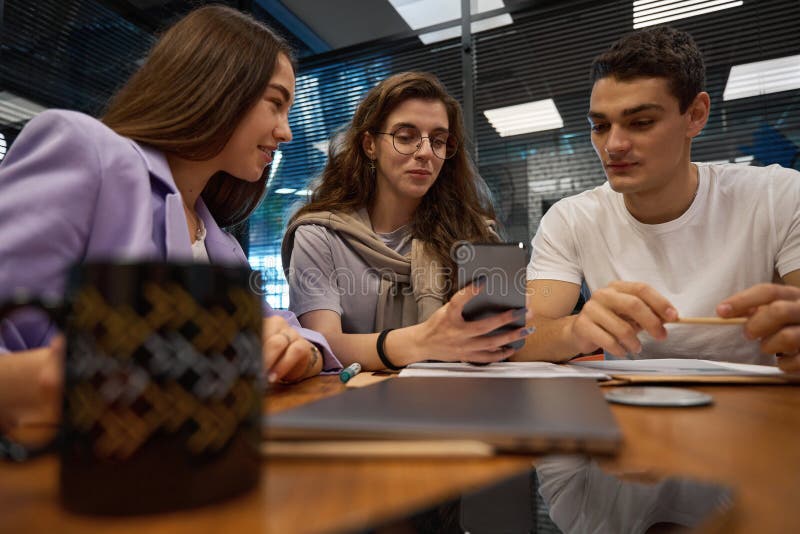 Colleagues Looking at Photos on the Phone during a Break Stock Image ...