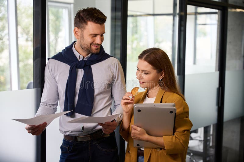 Colleagues, Man and a Woman are Looking through Work Documents Stock ...