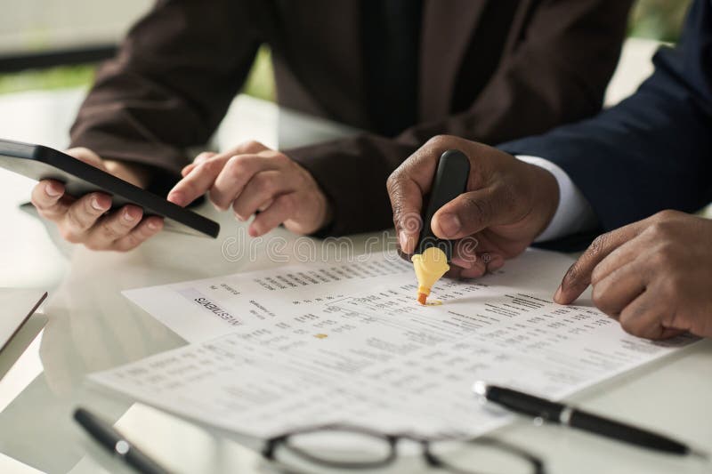 Colleagues Marking Financial Data on Paper Stock Photo - Image of ...