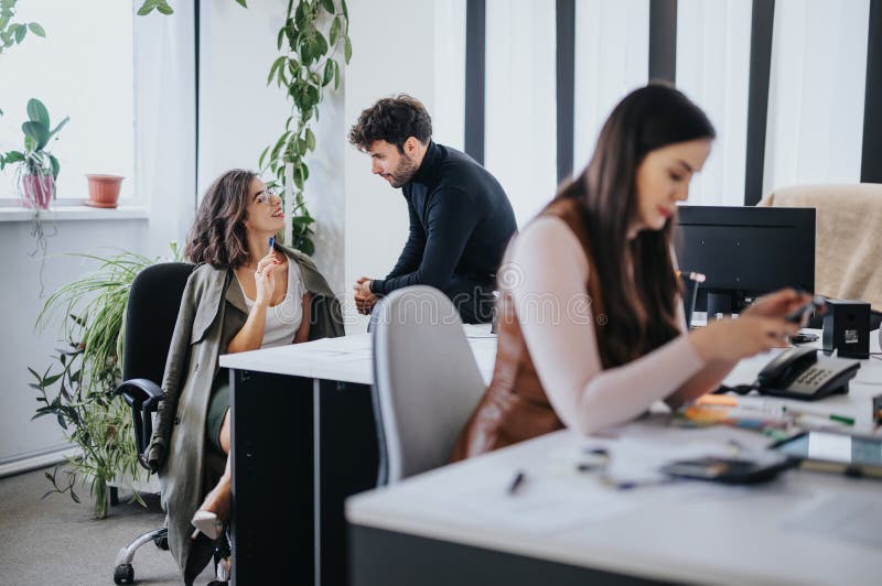 Colleagues in a Modern Office Environment Engaging in Discussion with ...