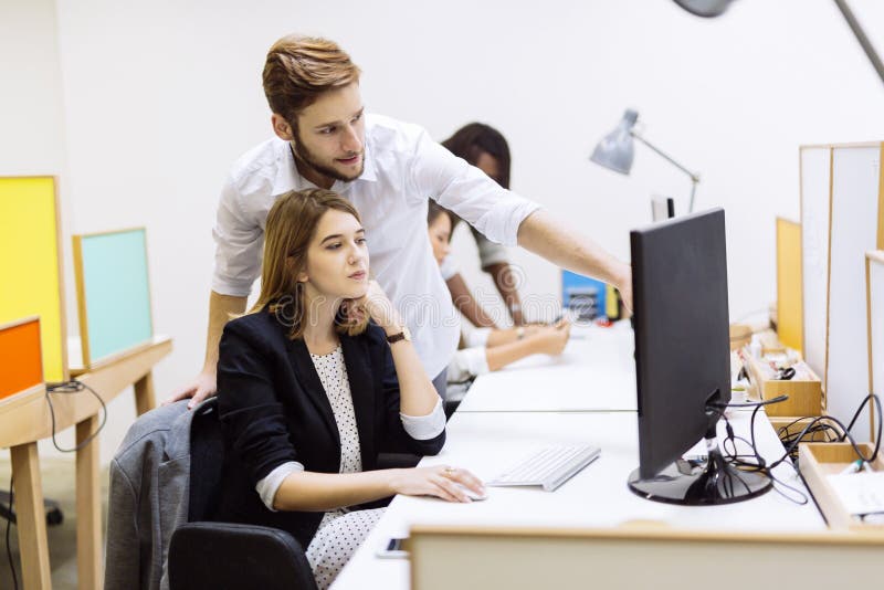 Colleagues in Office Working on a Computer Stock Photo - Image of women ...