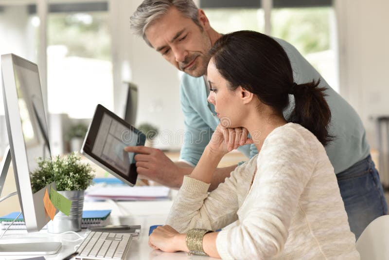 Colleagues in Office Working on Desktop Stock Image - Image of ...