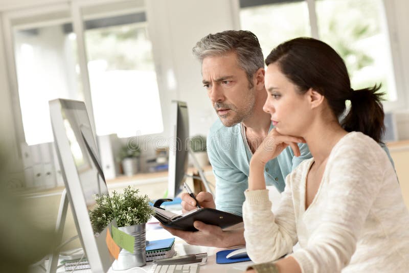 Colleagues in Office Working on Desktop Stock Photo - Image of attire ...