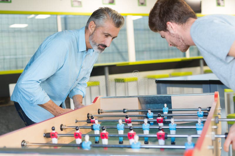Colleagues Playing Table Soccer Game Inside Office Stock Image - Image ...