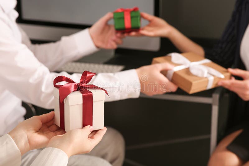 Colleagues Presenting Gifts Each Other in Office, Closeup. Space for ...