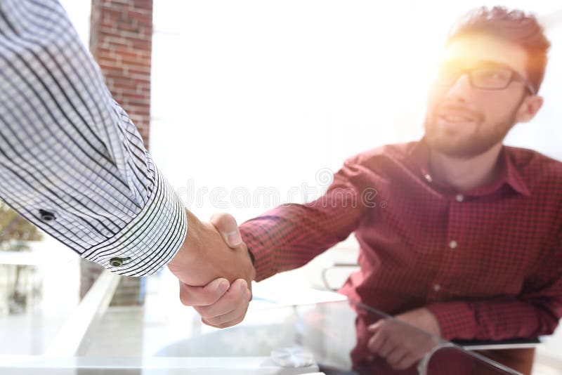 Colleagues Shaking Hands Over Desk Stock Image - Image of businessman ...