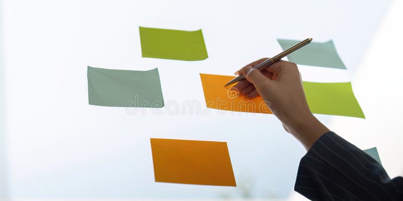 Colleagues Sharing Insights while Arranging Sticky Notes for Project ...