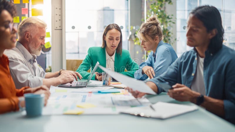 Colleagues Sit Behind Conference Table at the Office and Discuss ...