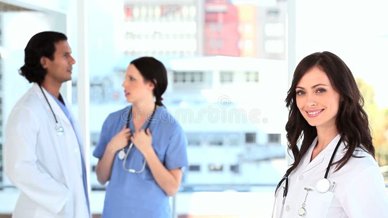 Colleagues Talking Behind a Doctor Stock Footage - Video of ...