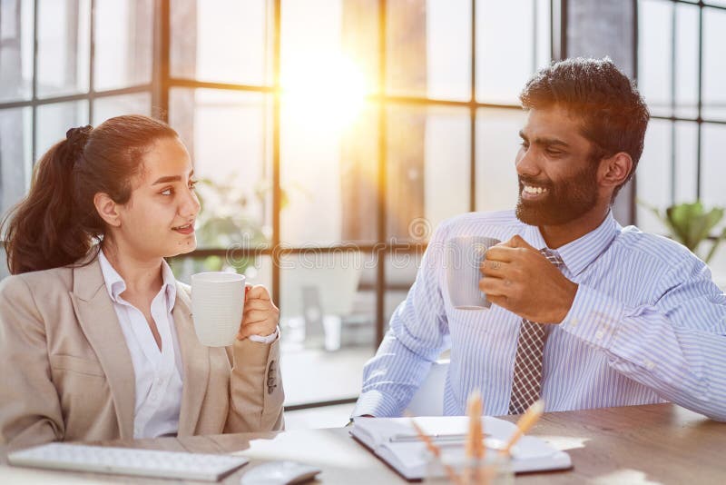 Colleagues Talking during Lunch Break while Sitting at Workplace Stock ...