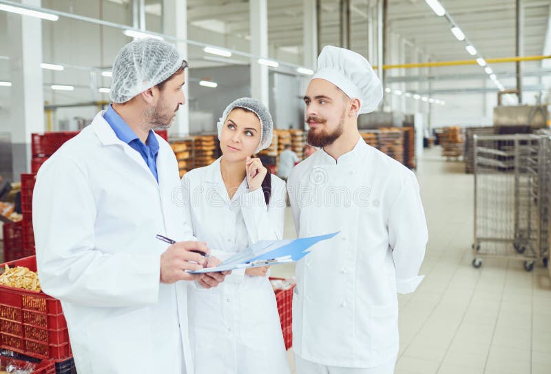 Colleagues Technologists in White Uniform at the Production of Food ...