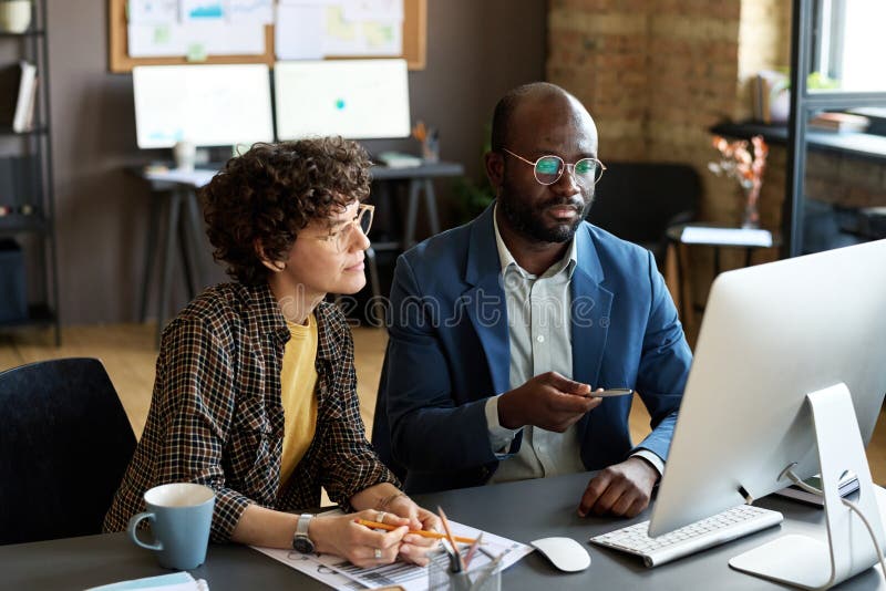 Colleagues Using Computer at Work Stock Photo - Image of teamwork ...