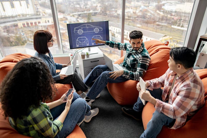 Colleagues Using Devices while Talking about Car Design Stock Photo ...