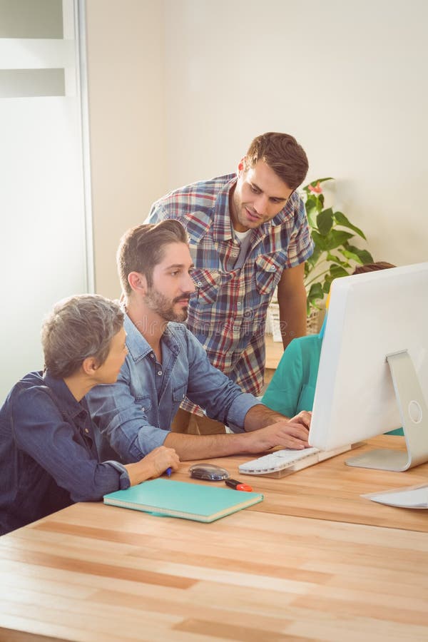 Colleagues Using Laptop at Office Stock Photo - Image of briefing ...
