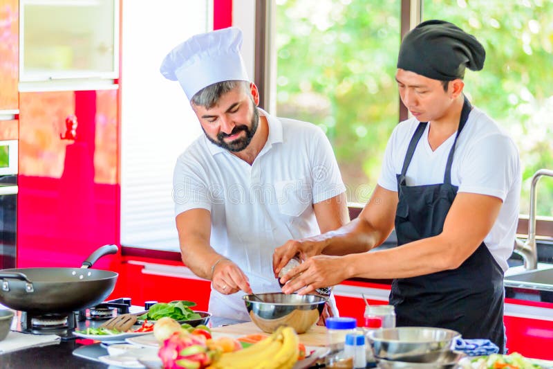 Colleagues at Work: Thai and European Chefs at the Kitchen Doing Stock ...