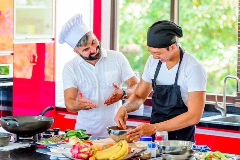 Colleagues at Work: Thai and European Chefs at the Kitchen Doing Stock ...