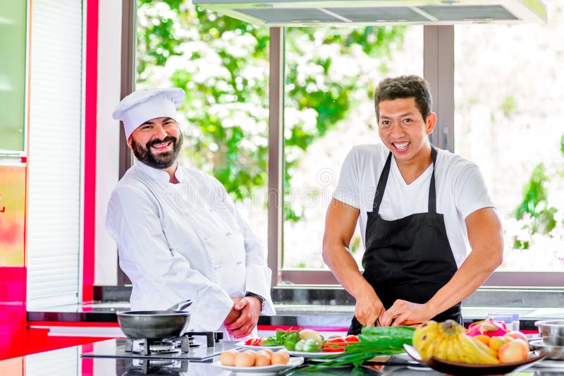 Colleagues at Work: Thai and European Chefs at the Kitchen Doing Stock ...