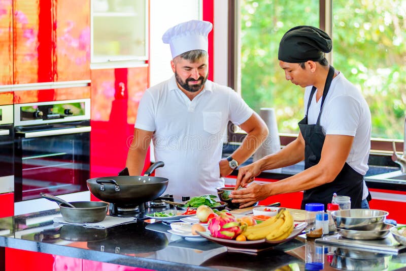 Colleagues at Work: Thai and European Chefs at the Kitchen Doing Stock ...