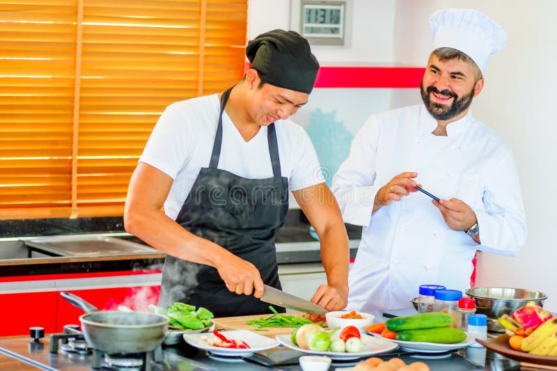 Colleagues at Work: Thai and European Chefs at the Kitchen Doing Stock ...