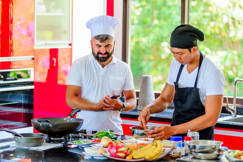 Colleagues at Work: Thai and European Chefs at the Kitchen Doing Stock ...