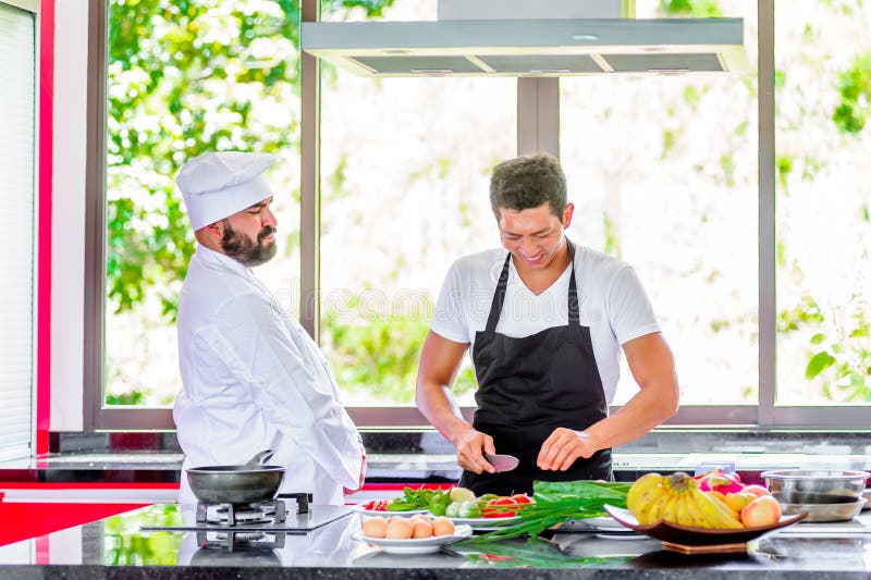 Colleagues at Work: Thai and European Chefs at the Kitchen Doing Stock ...