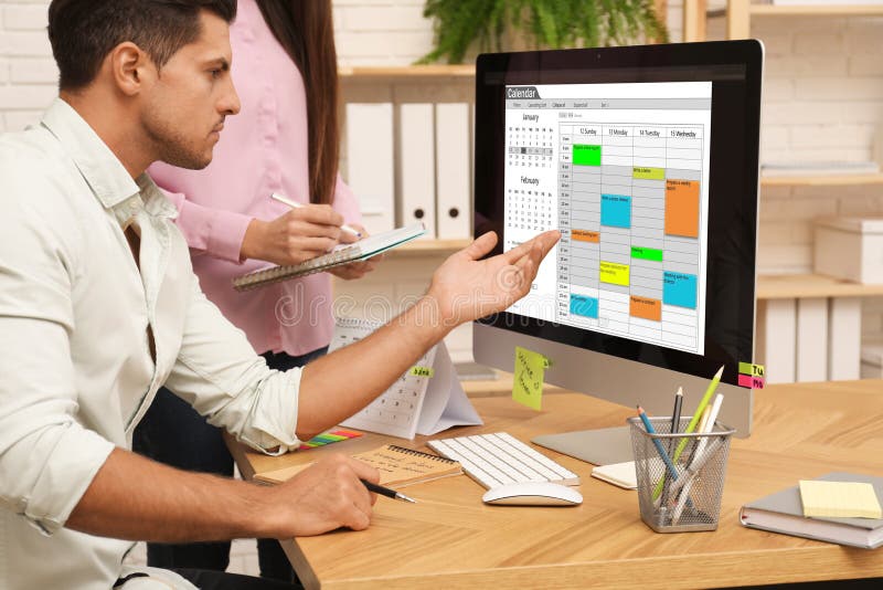 Colleagues Working with Calendar App on Computer Stock Photo - Image of ...