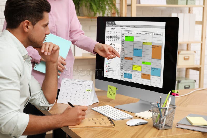 Colleagues Working with Calendar App on Computer Stock Photo - Image of ...