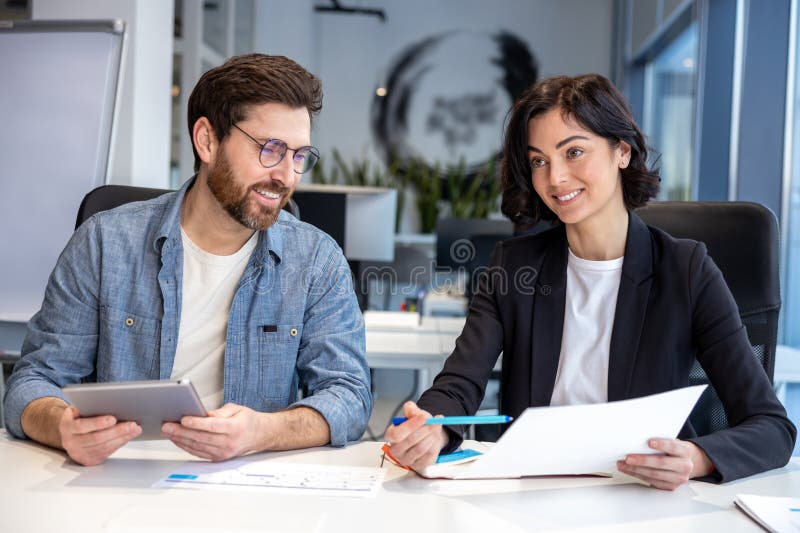 Colleagues Working in Collaborative Office Environment Stock Photo ...