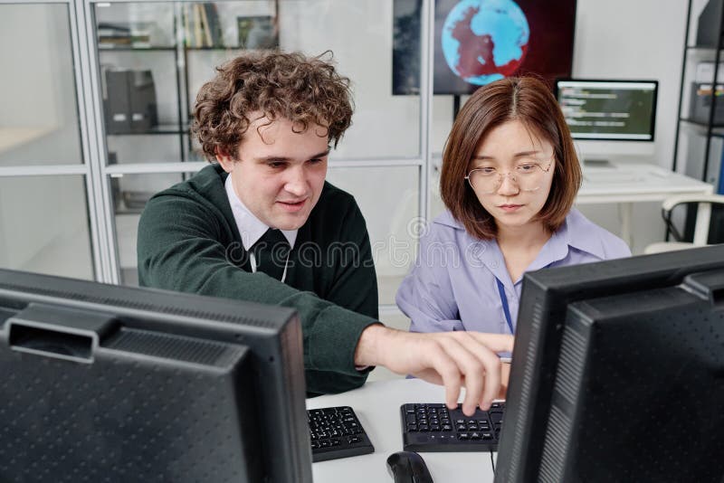 Colleagues Working with Program in Team Stock Photo - Image of office ...