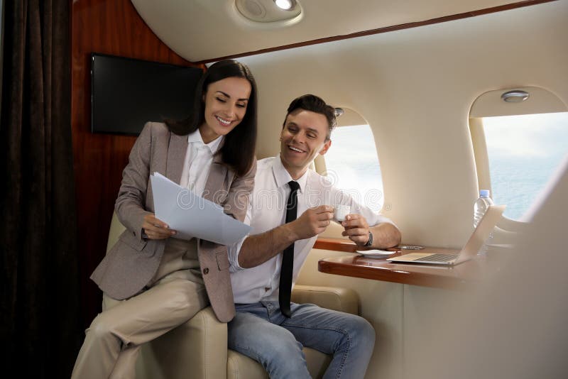 Colleagues Working in Airplane during Flight Stock Photo - Image of ...