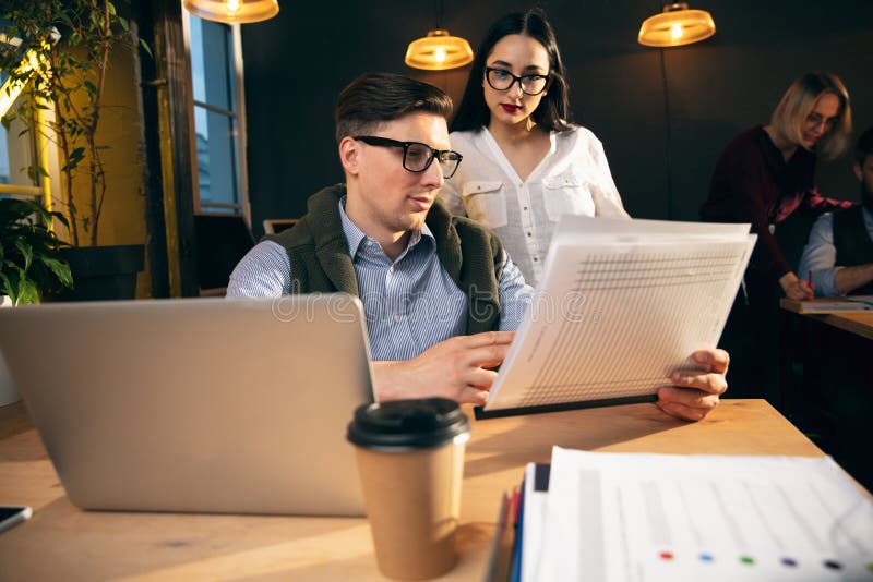 Colleagues Working Together in Modern Office Using Devices and Gadgets ...
